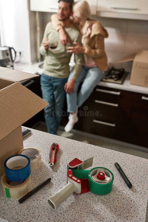 Packing Objects and Box on Table with Blur Couple Stock Image - Image ...