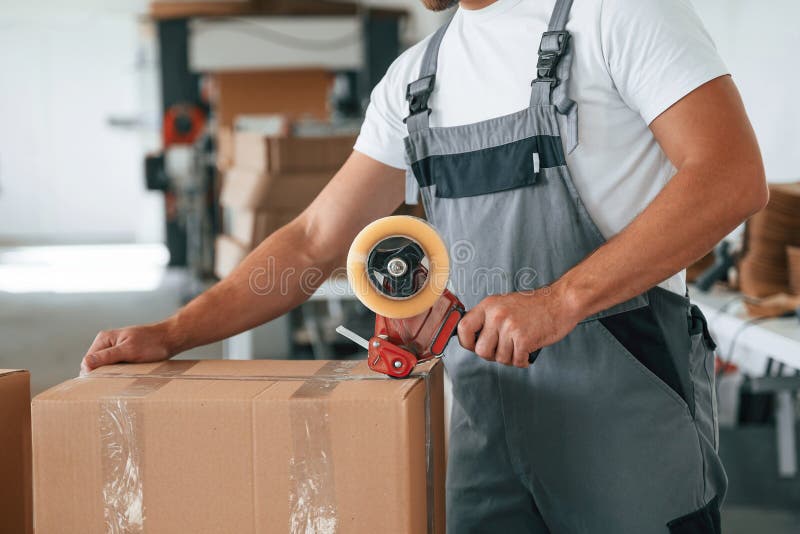 Packing the Product. Handsome Man is Working at the Factory of Creating ...