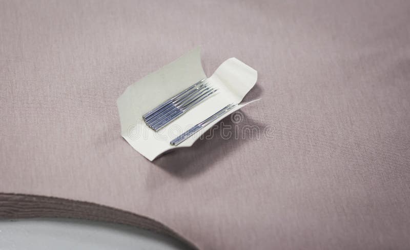 Packing of Sewing Machine Needles on Knitted Fabric Stock Photo - Image ...