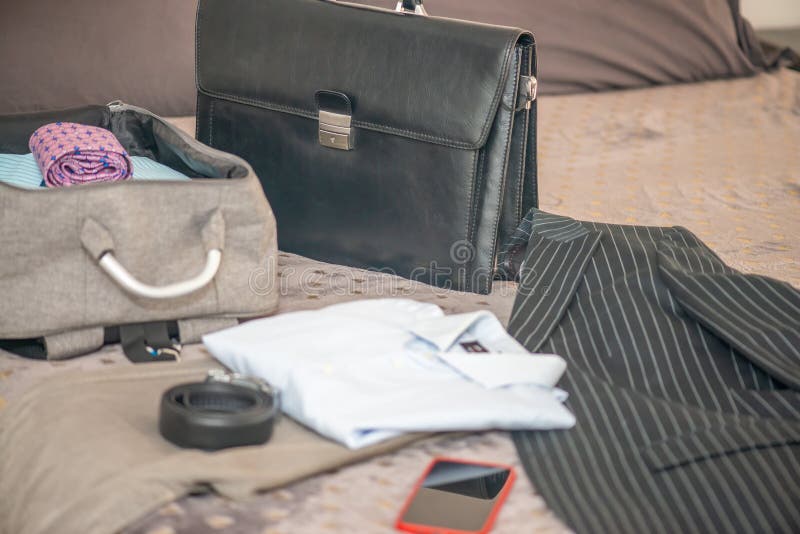 Packing Suitcase for Business Travel. Clothes and Briefcase on the Bed ...