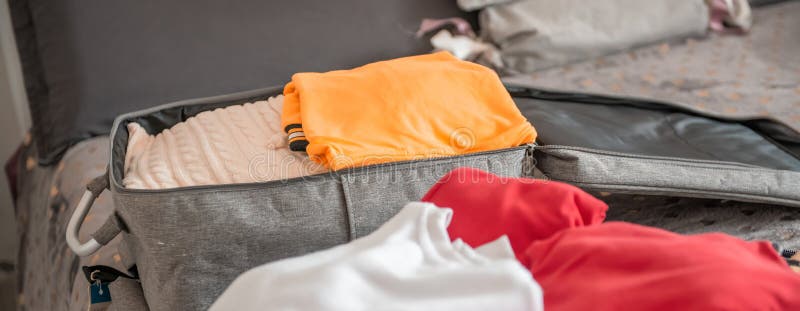 Packing for a Trip. Suitcase with Clothes on the Bed Stock Image ...