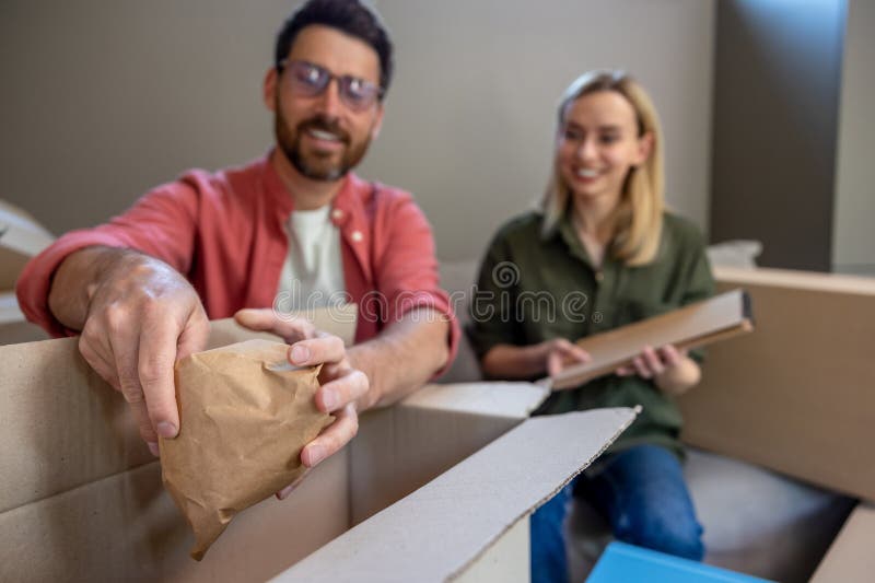Two People Looking Busy while Packing the Boxes for Relocation Stock ...