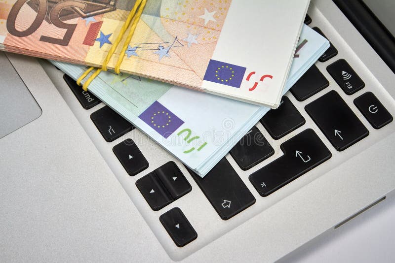 Packs of 100 and 50 Euro Bills Lie on the Computer Keyboard, Top View ...