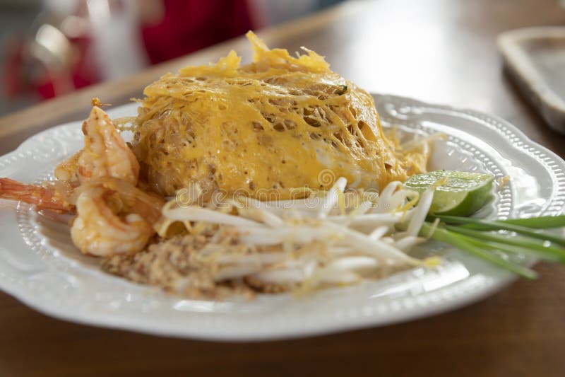 Pad Thai Wrapped in Egg on a White Plate Stock Image - Image of noodle ...