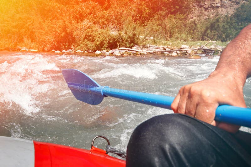 Paddle in Hand on the Edge of a Raft Rafting Down a Mountain River ...