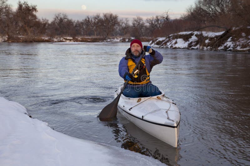 Paddling Canoe on a Winter River Stock Photo - Image of winter, mature ...