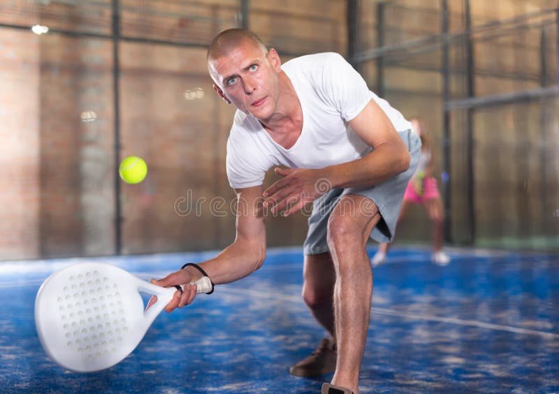 Padel Player Playing Padel in a Padel Court Indoor Behind Net Stock ...