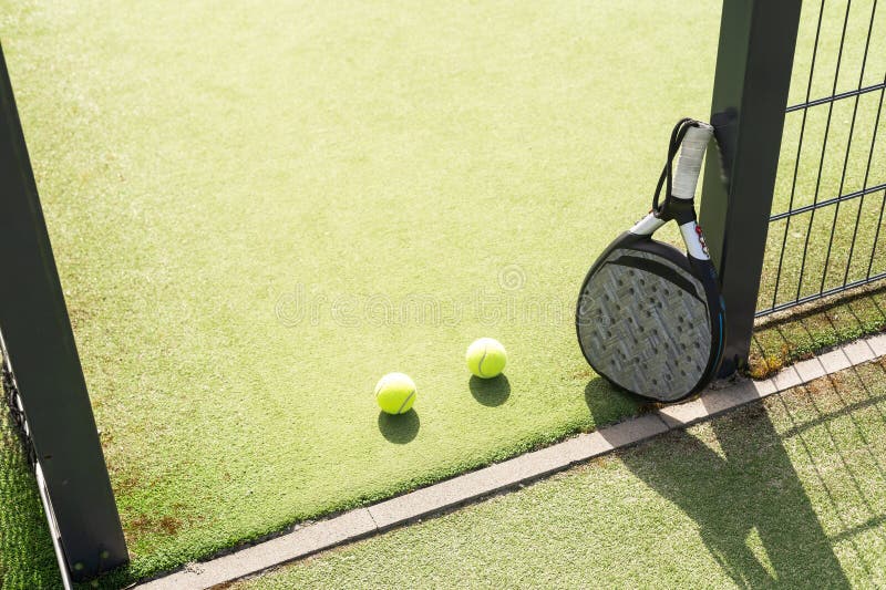 Padel Racket and Padel Ball on a Green Court in the Sunset Stock Photo ...