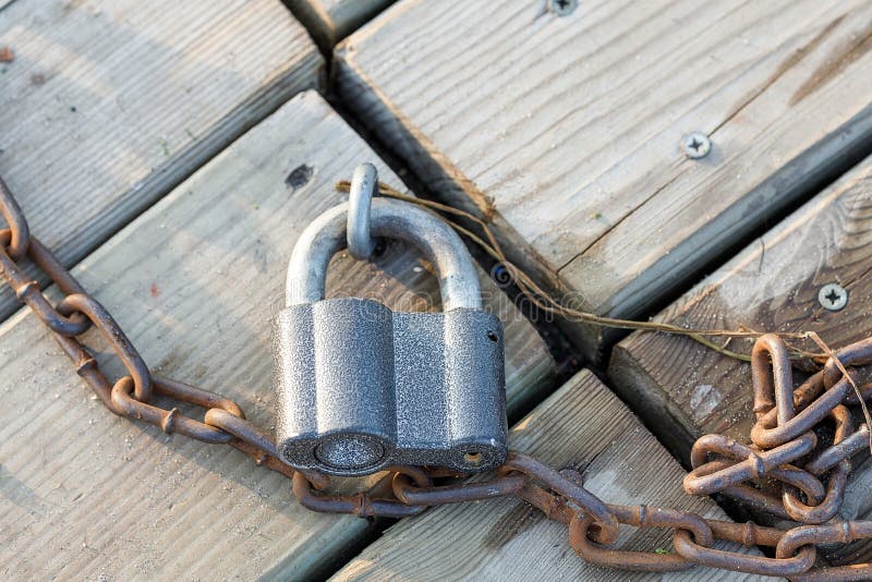 Old Chain Closed with a Rusty Padlock Hangs Above the Concrete Table ...