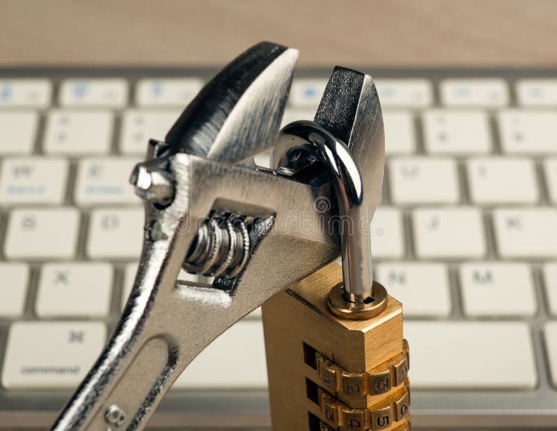 Padlock Hanging on an Adjustable Wrench Against a Computer Keyboard ...