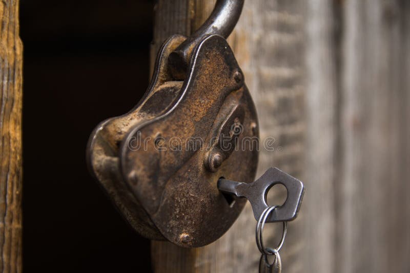 A Padlock Hangs on the Door Hinge Stock Image - Image of latch, iron ...