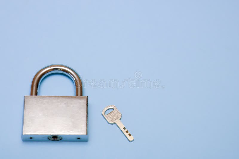 Padlock and Key on a Blue Background with Copy Space, Security ...