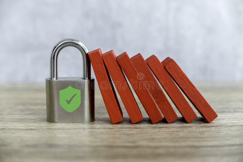 Padlock with Security Shield Blocking Falling Red Dominoes on Wooden ...