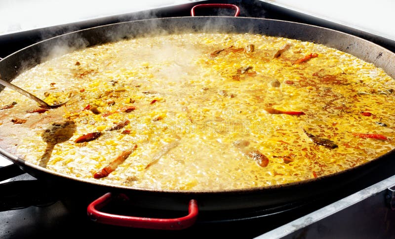 Paella Rice from Valencia Spain Cooking in Big Pan Stock Image - Image ...