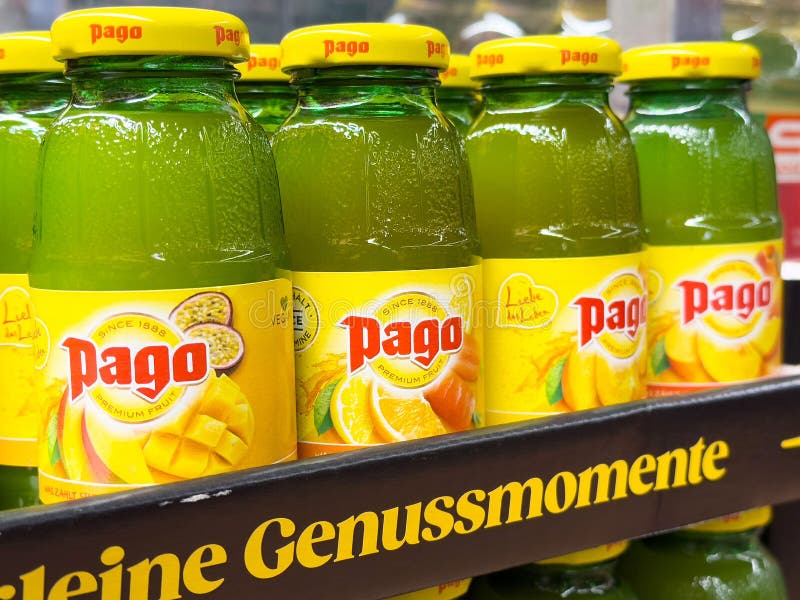 Pago Fruit Juice Bottles Display on Store Shelf with Bright Yellow ...
