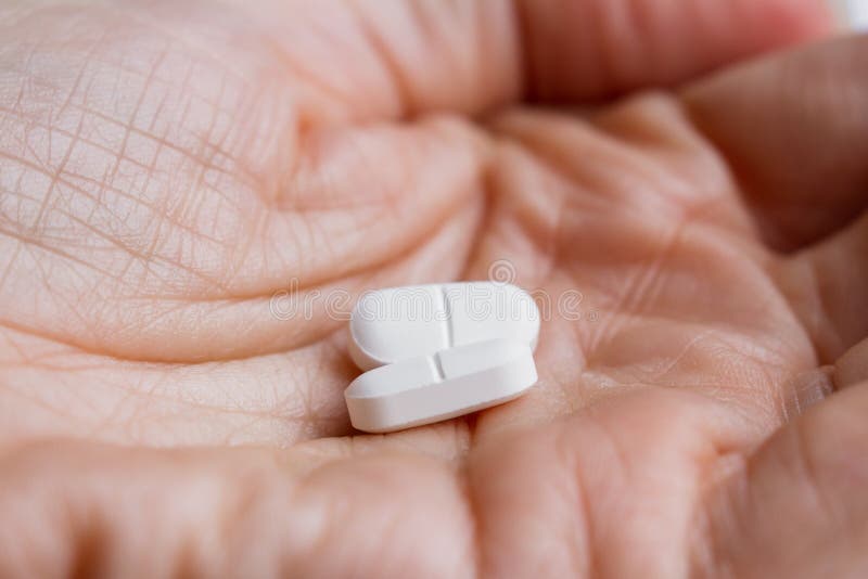 Pain killers in a hand stock image. Image of prescribed - 104354027