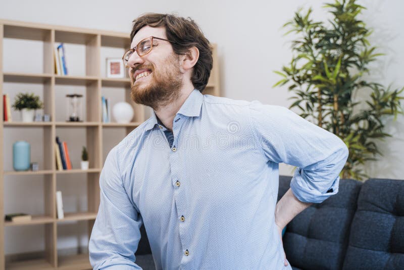 Painful Guy Aching from Pain in Back or Reins at Home Stock Image ...