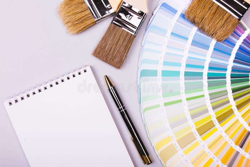 Paint Brush Laying on Heap of Color Samples. Open Can of Green Paint ...