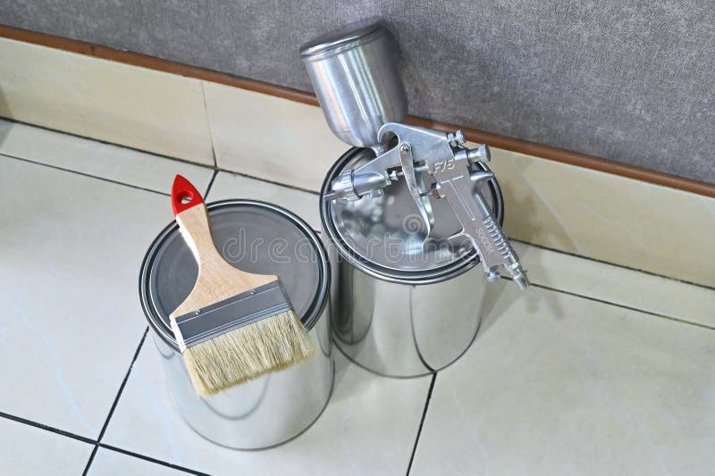Paint Brush and Spray Gun Isolated on Tin Cans Stock Photo - Image of ...