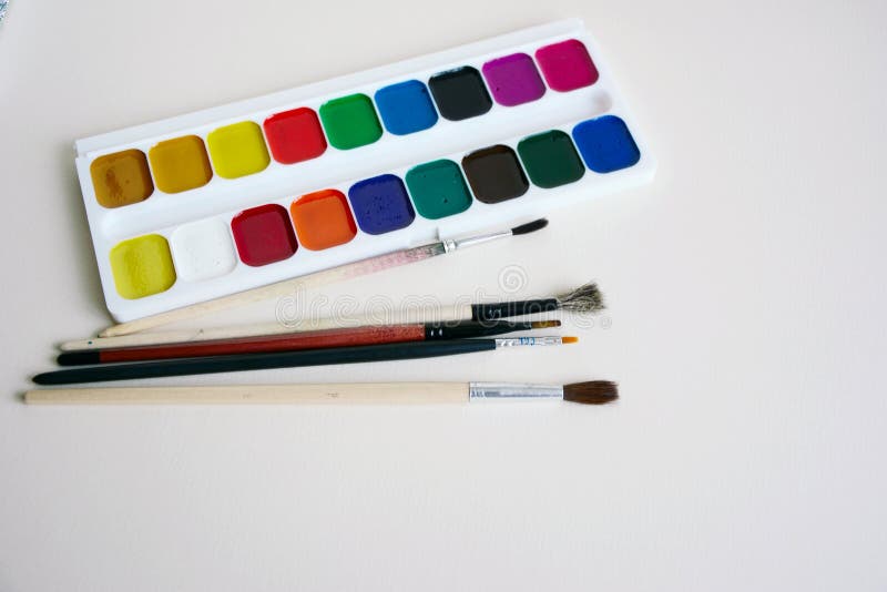 Paint Brushes and a Set of Paints on a White Paper Stock Image - Image ...