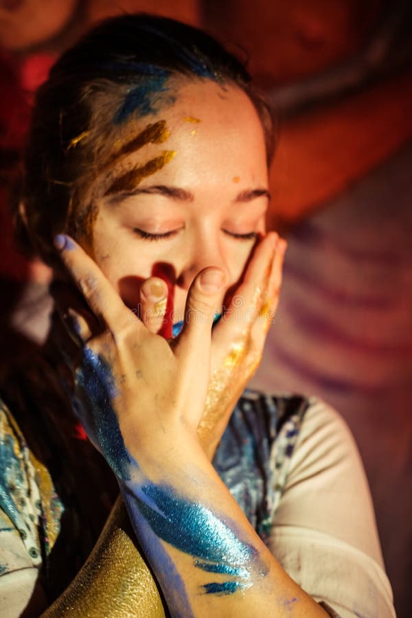 Paint on the Face and Body of a Woman. a Woman in the Spotlight Poses ...