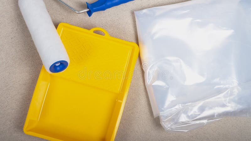 Paint Roller and Yellow Tray on Concrete Floor Stock Photo - Image of ...