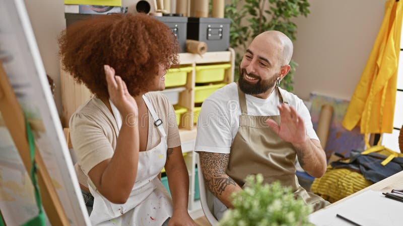 Two Smiling Artists High Five, Celebrating Their Painting Success in ...