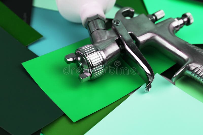 A Paint Spray Gun at Work at the Workplace in the Workshop. Paint ...