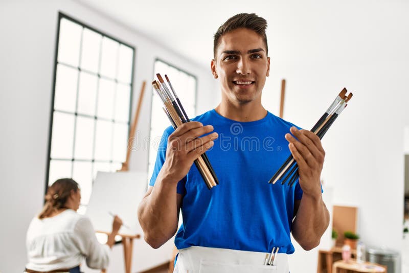 Paint Student Man Smiling Happy Holding Paintbrushes at Art School ...