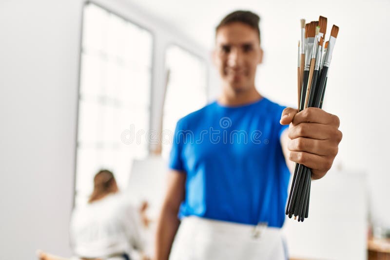 Paint Student Man Smiling Happy Holding Paintbrushes at Art School ...