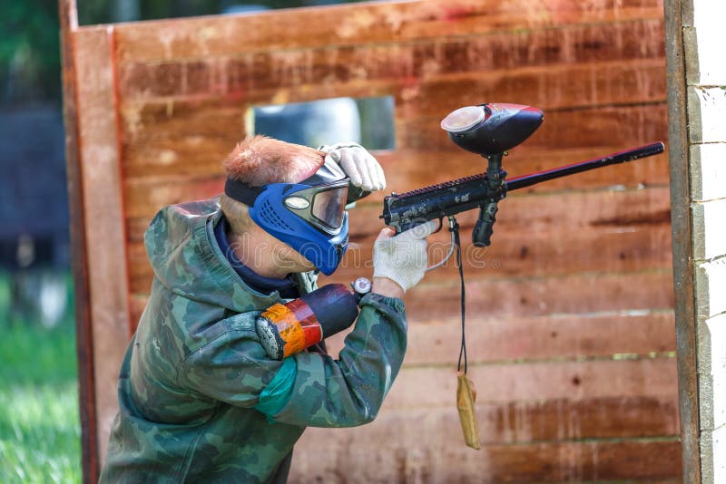 Paintball Player in Blue Helmet Shooting from Paint Gun Stock Image ...