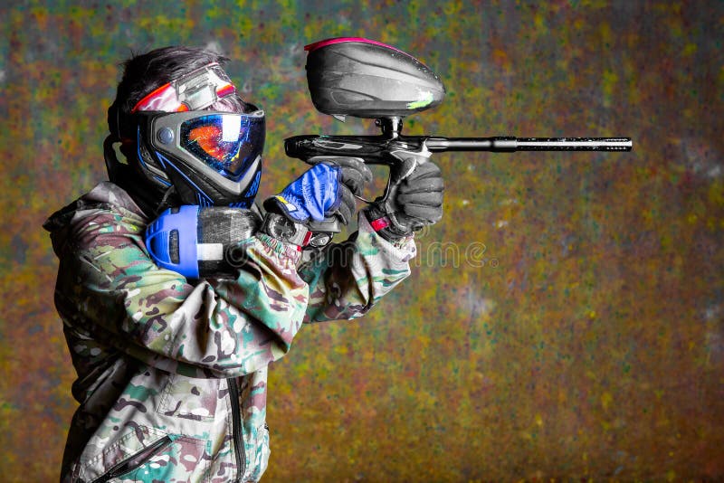 Paintball Player in Protective Uniform Shooting Target with Gun Stock ...