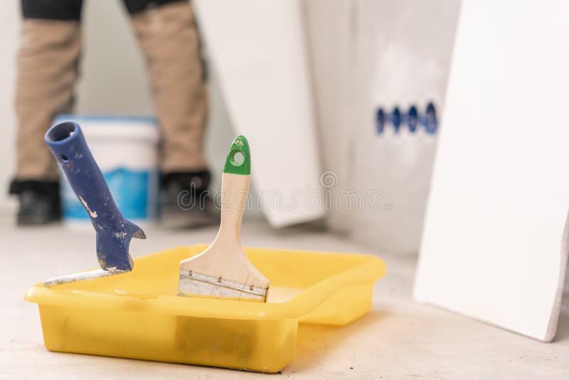 Paintbrush, Roller and Glue Container on Concrete Surface. Composition ...