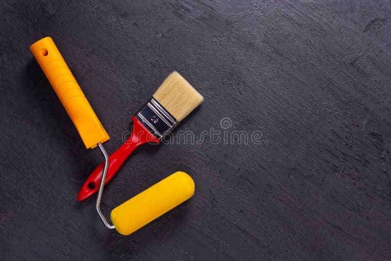 Paintbrush Tool and Paint Roller at Black Background. Construction ...
