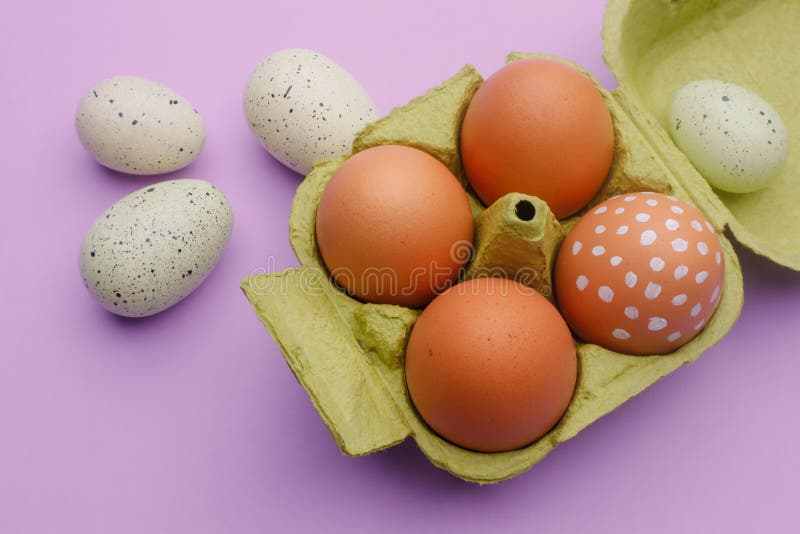 Painted Easter Eggs in Cardboard Boxes on a Purple Background Stock ...