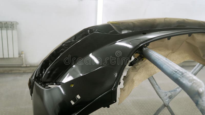 Painted Car Bumper in Garage. Black Bumper Freshly Painted. Stock Image ...