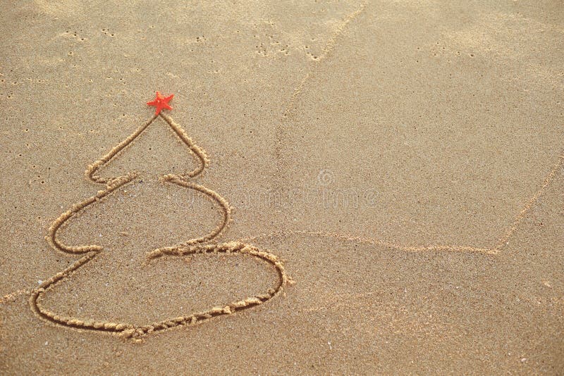 Painted Christmas Tree in the Sand on the Beach. Stock Photo - Image of ...