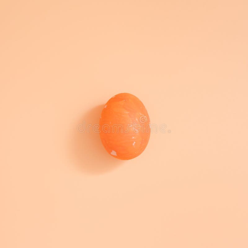 Painted Easter Egg in Orange Color. Beige Background Stock Photo ...