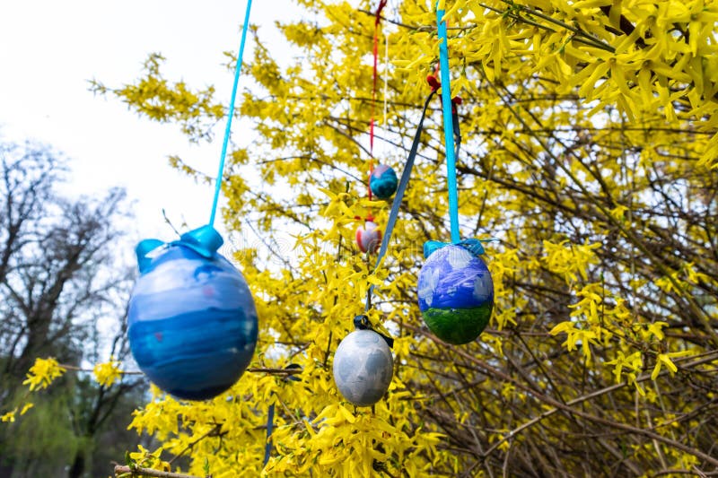 Painted Easter Eggs Decorate the Branches of a Bush Blooming with ...