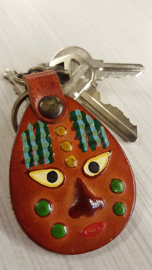 Painted Face Key Ring on Grey Table Stock Image - Image of table, face ...