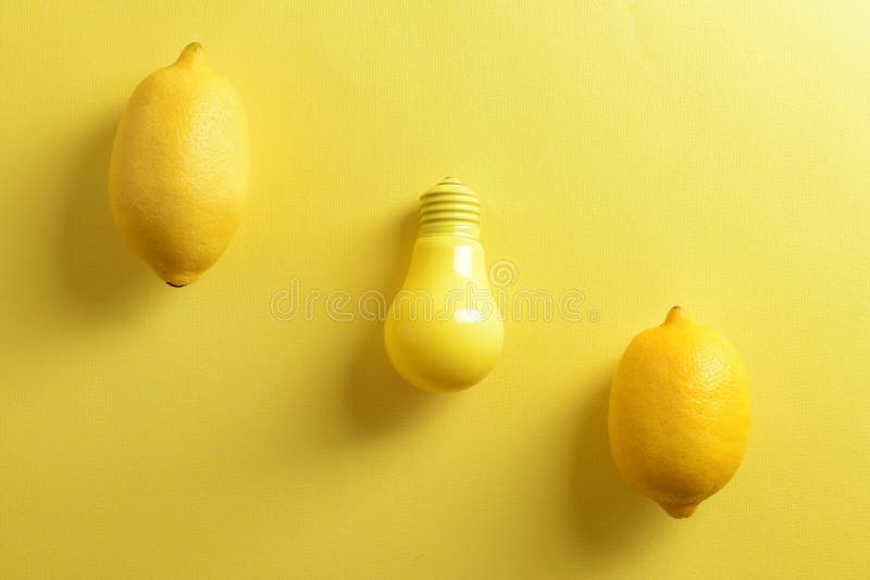 Painted Light Bulb with Fresh Lemons on Color Background Stock Image ...