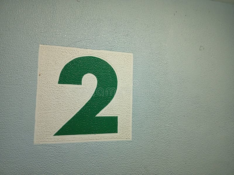 Painted Number Two on Plain Blue Wall White and Green Stock Image ...