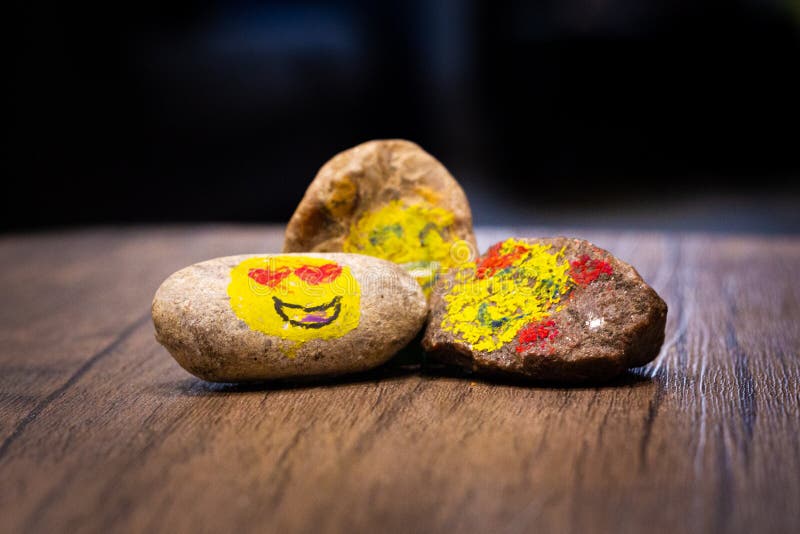 Painted Pebbles with Emoji Faces on a Table Stock Image - Image of arts ...