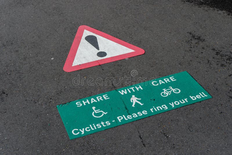 A Painted Sign on a Pavement Asking Cyclists To Beware of Pedestrians ...