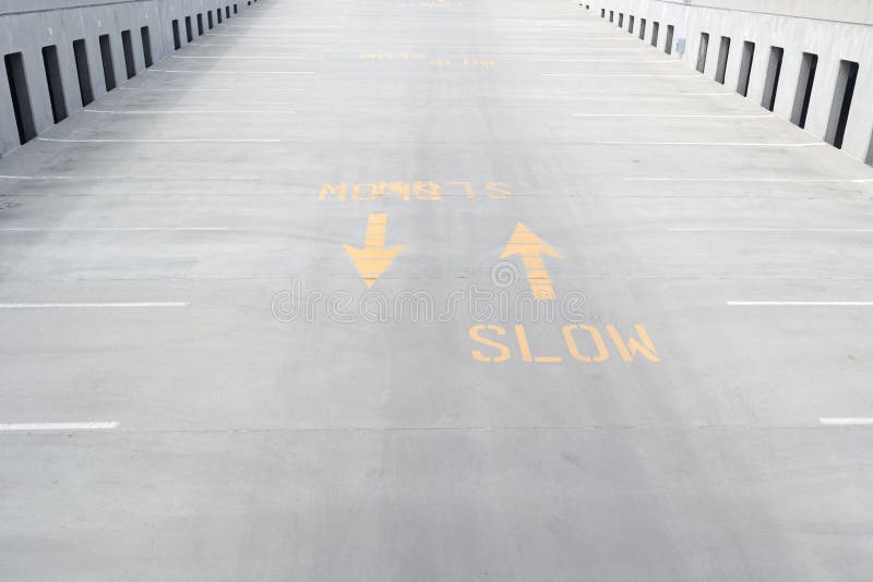 Painted Slow Sign with Arrows on Concrete Ramp Stock Image - Image of ...