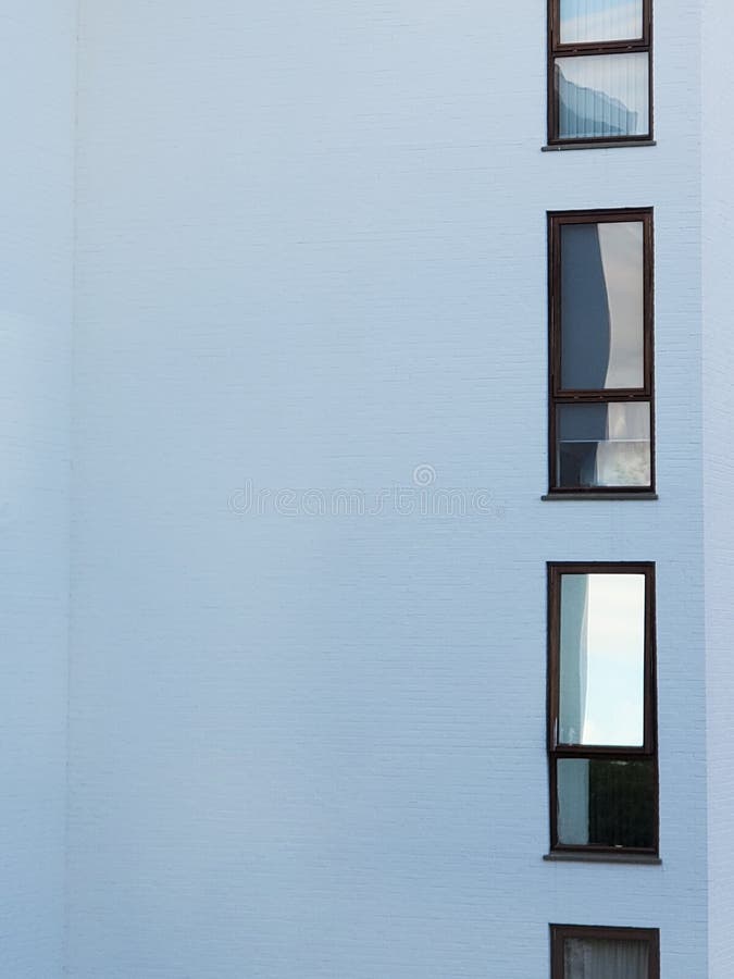 Painted White Brick Wall with Line of Tall Windows Down Side Stock ...