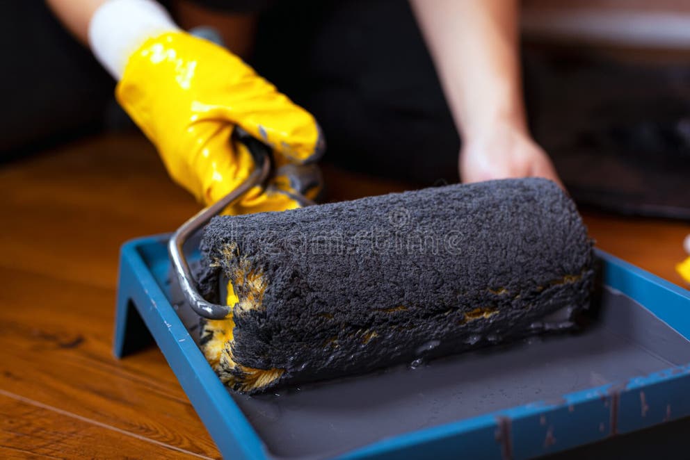 Painter Dips Roller in a Tray with Paint. Redecoration in the House ...