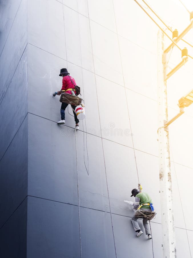 Painter Fixing the Wall and Painting on the Wall of the Building ...