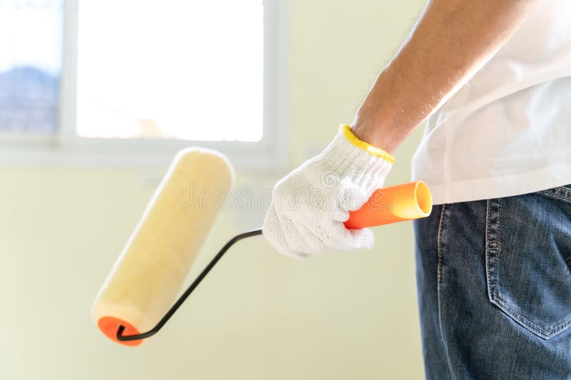 Painter Man Hands with Gloves Holds Painting Roller for Renovation ...