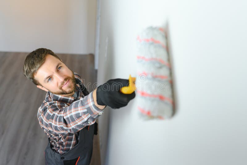 Painter Man Painting the Wall, with Paint Roller Stock Photo - Image of ...